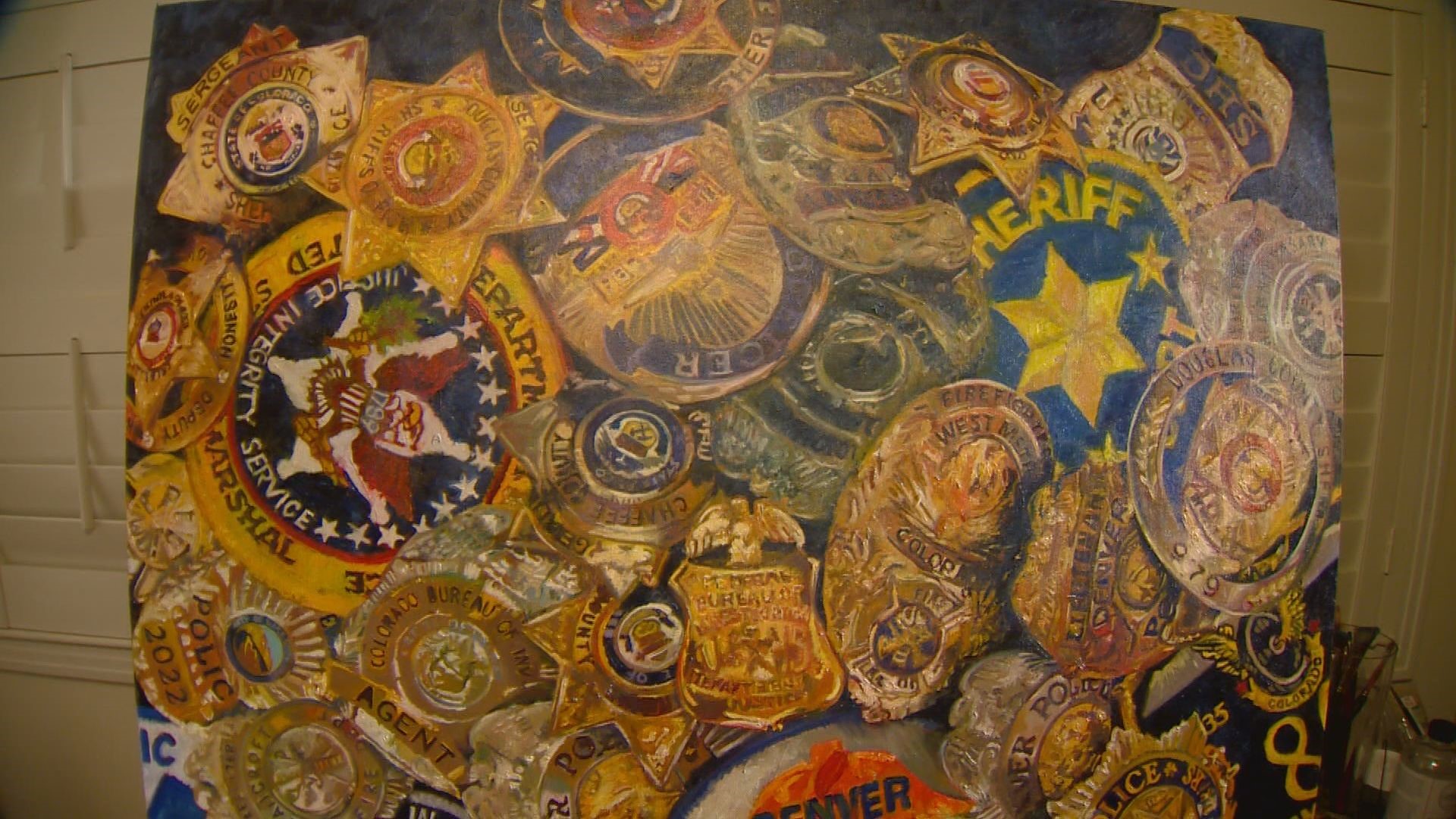 Artist inspired by love creates painting of first responder badges ...