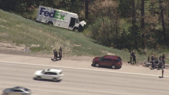 PHOTOS | Stolen FedEx crashes on side of I-25 | 9news.com