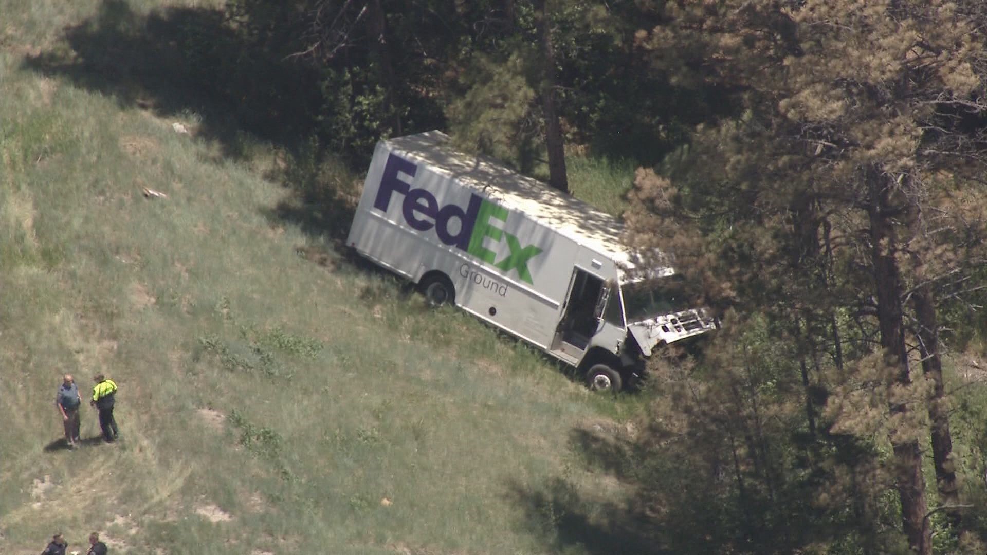 PHOTOS | Stolen FedEx crashes on side of I-25 | 9news.com