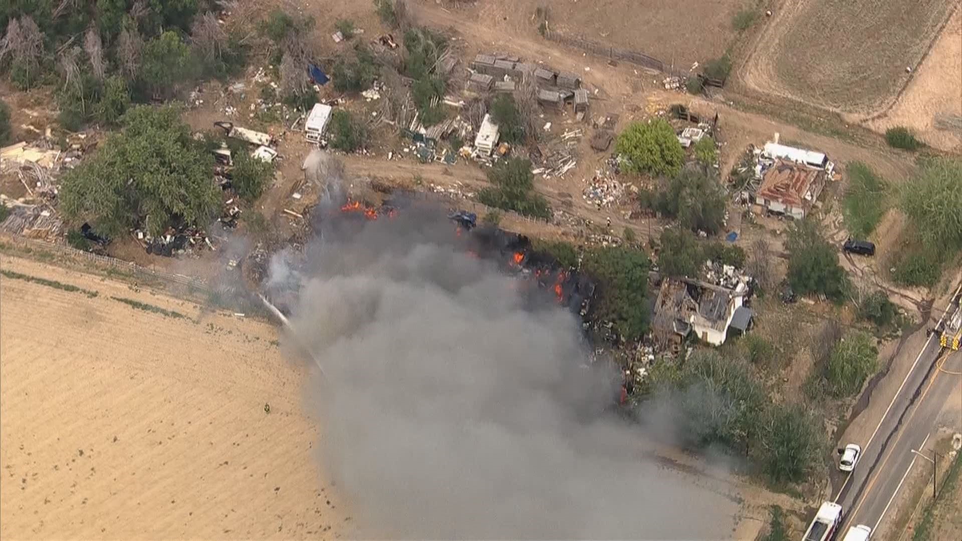 PHOTOS: Fire consumes garages, sheds north of Commerce City | 9news.com