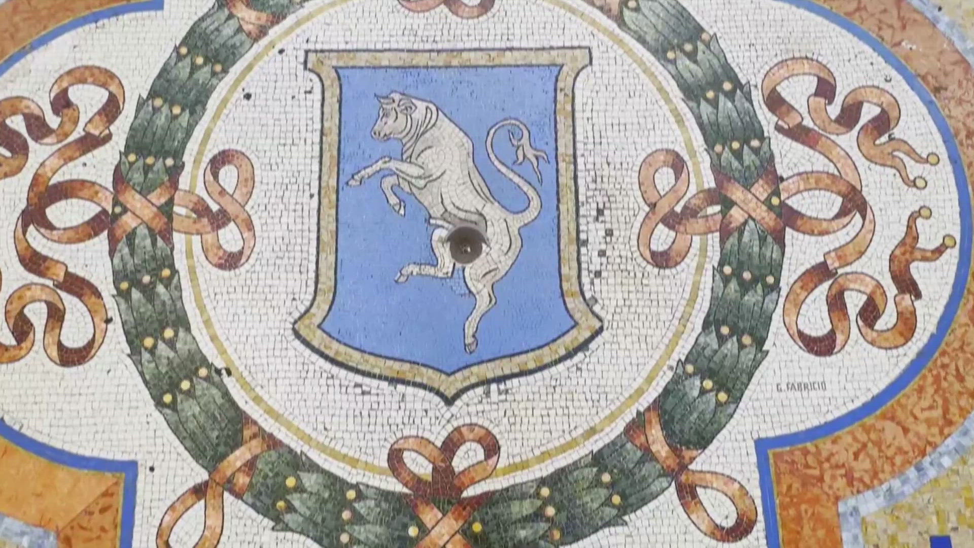 Olympic visitors spin for luck on Milan's famous bull | 9news.com