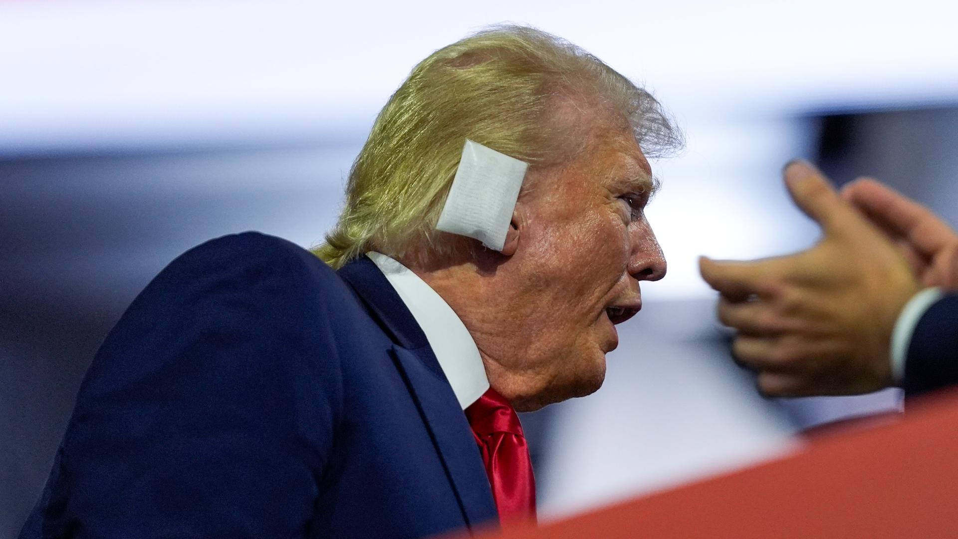 Trump receives hero's welcome with bandage on ear | 9news.com