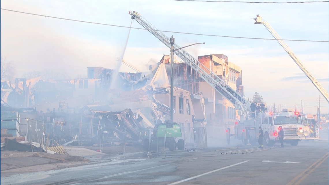 Smoke still rising, crowds gather as firefighters battle day-old 5 ...