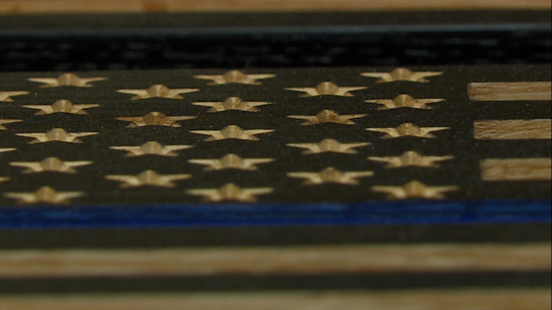 Centennial man honors officers with wooden blue line flags | 9news.com