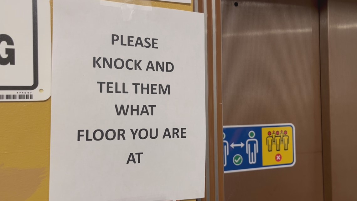 Broken elevator being operated manually by technician on top | 9news.com