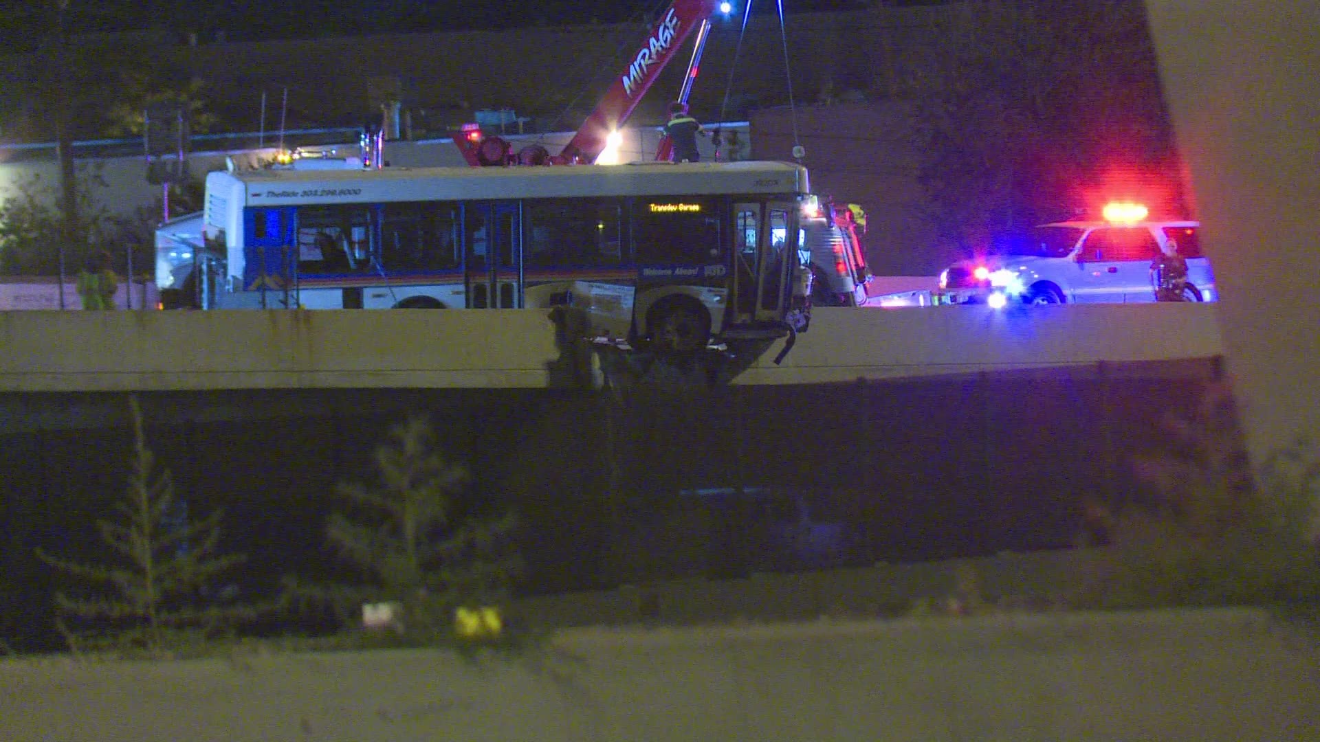 RTD bus crash leaves bus hanging over barrier | 9news.com